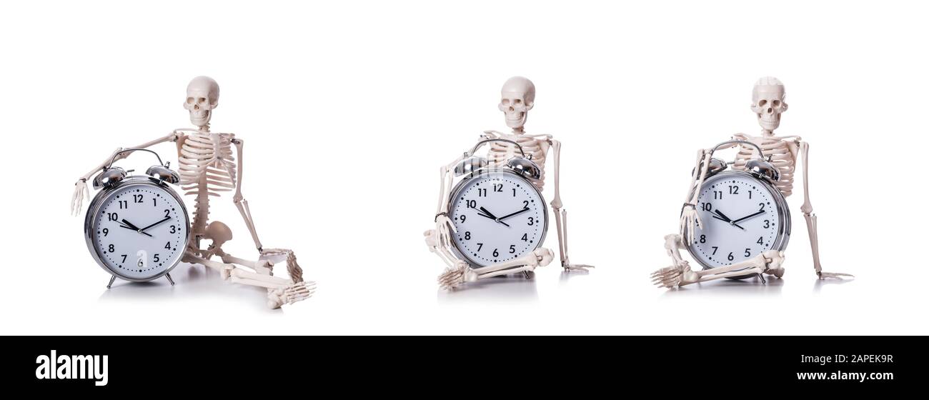 The skeleton with alarm clock on the white Stock Photo - Alamy