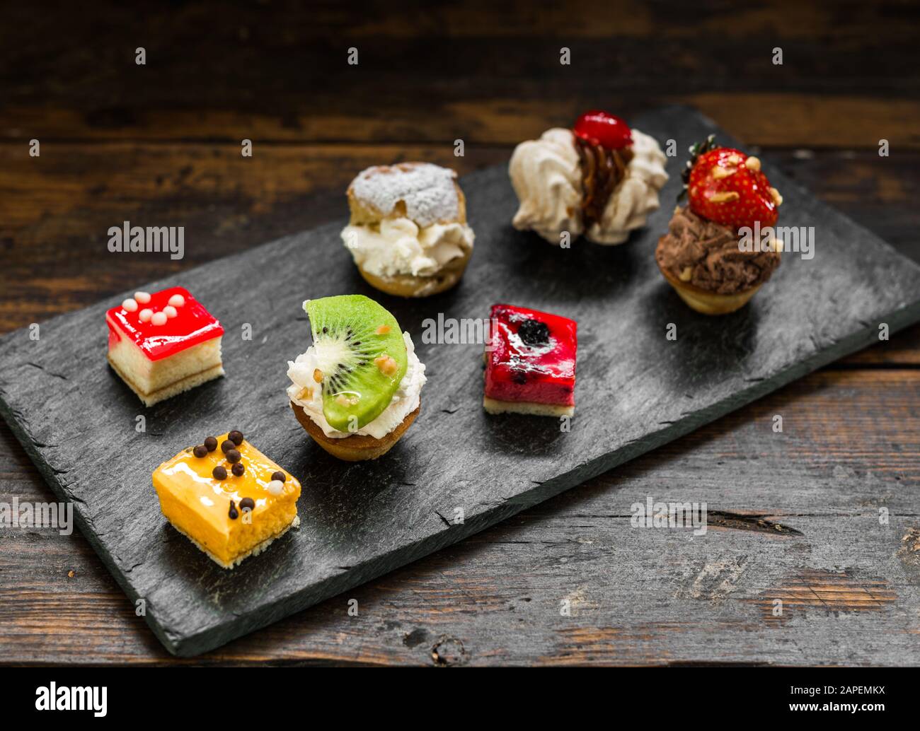 Selection of different dessert pastry sweet mini cakes and tartlets ...