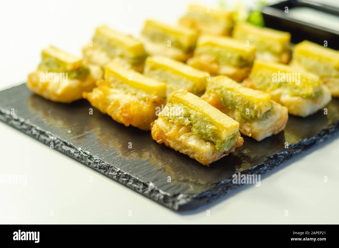 Skinless and boneless battered Alaska Pollock fillet pieces, topped ...