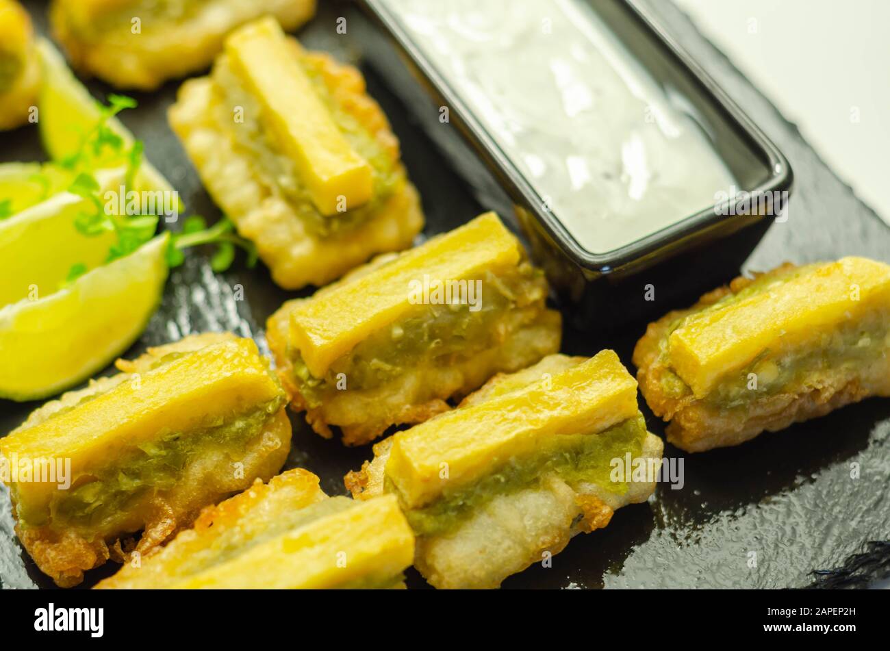 Skinless and boneless battered Alaska Pollock fillet pieces, topped ...