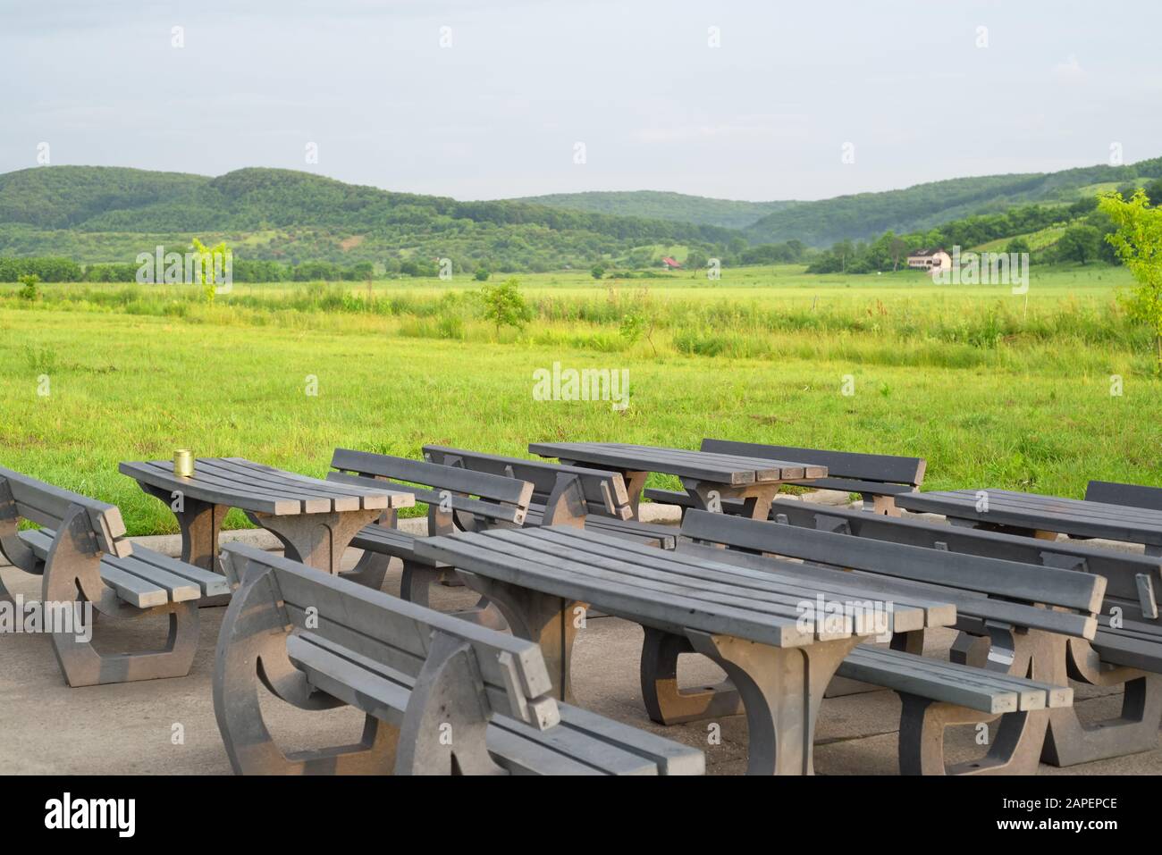 Benches and tables outdoors in a rustic landscape Stock Photo - Alamy