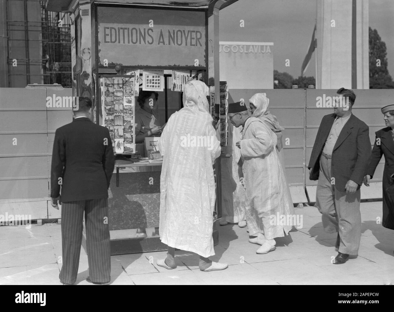 World Exhibition Paris 1937 Description: Visitors at a kiosk with ...