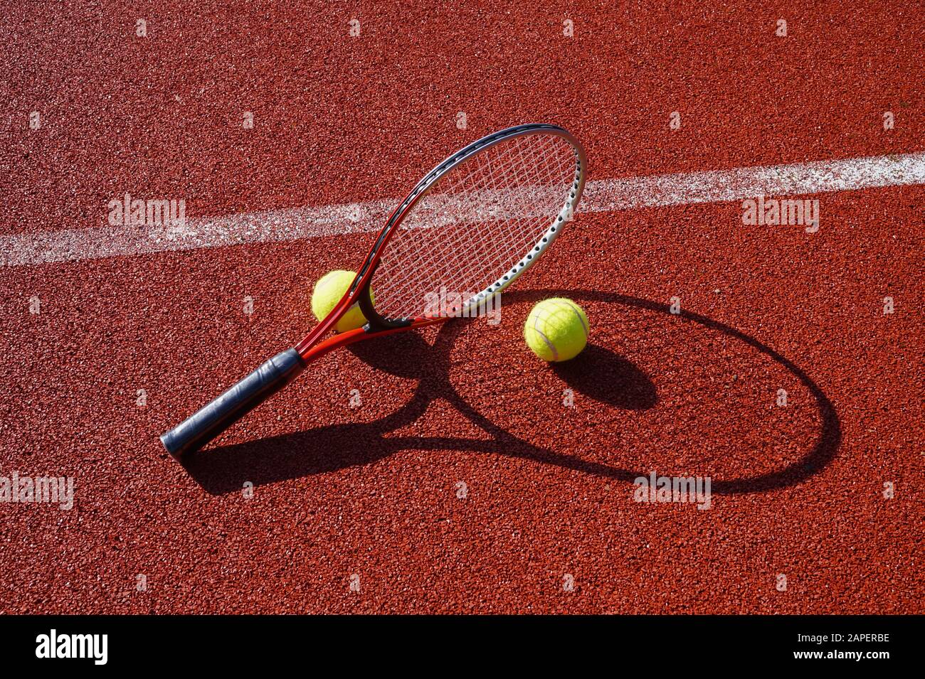 Tennis ball, line and racket on an outdoor court with the racket ...