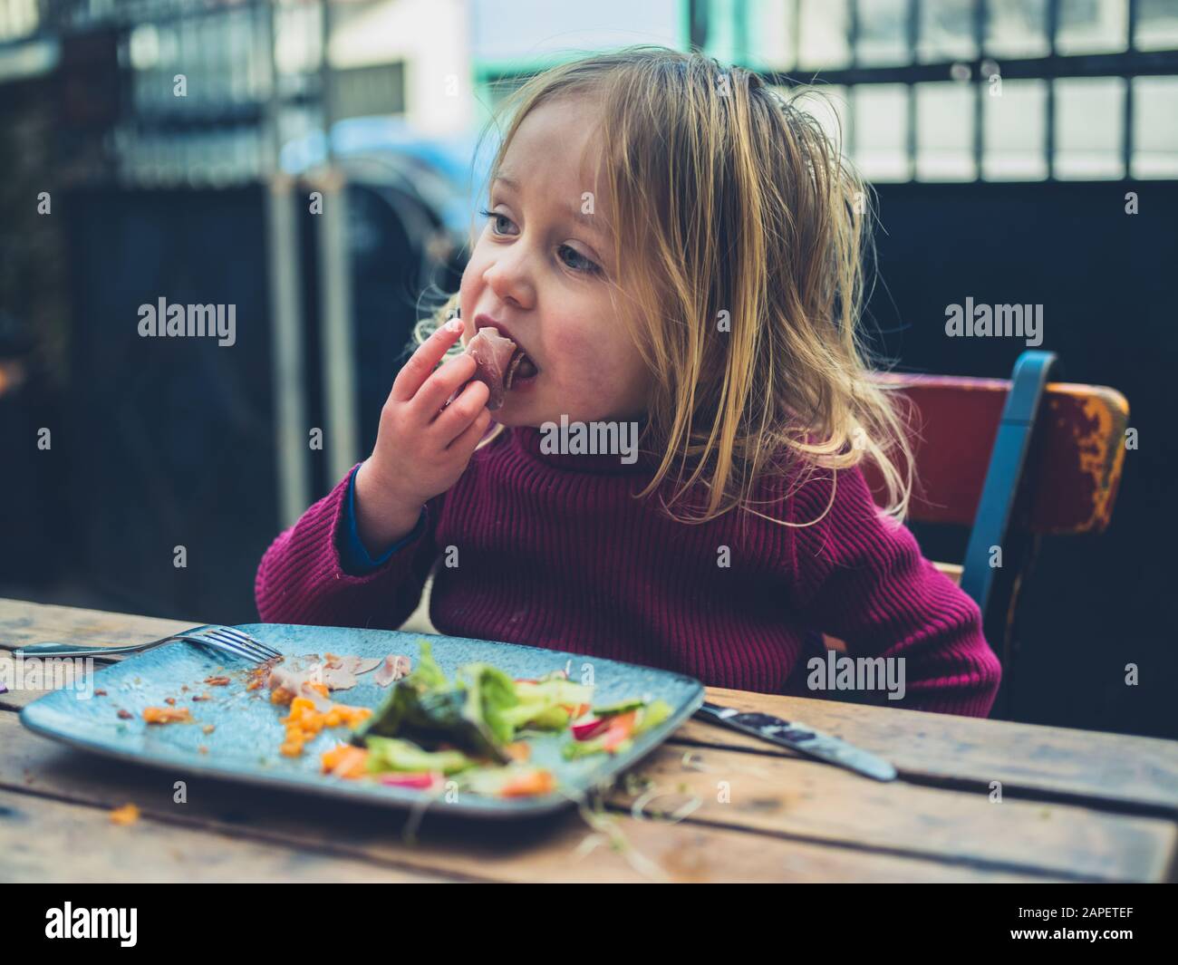 A little toddler is having his lunch in a cafe Stock Photo - Alamy