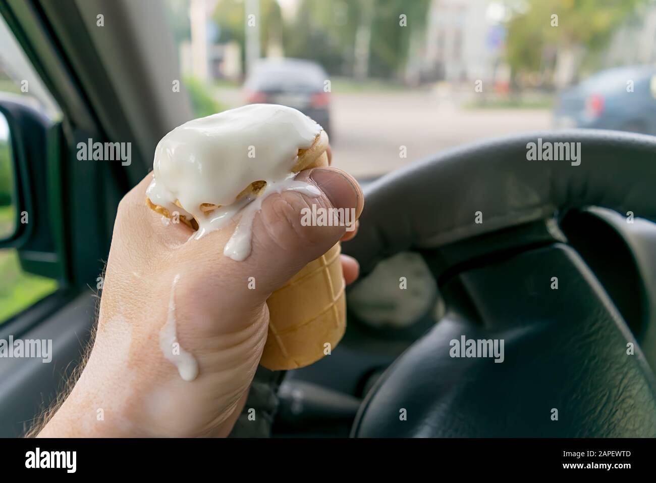 the driver holds the ice cream while driving a car Stock Photo - Alamy