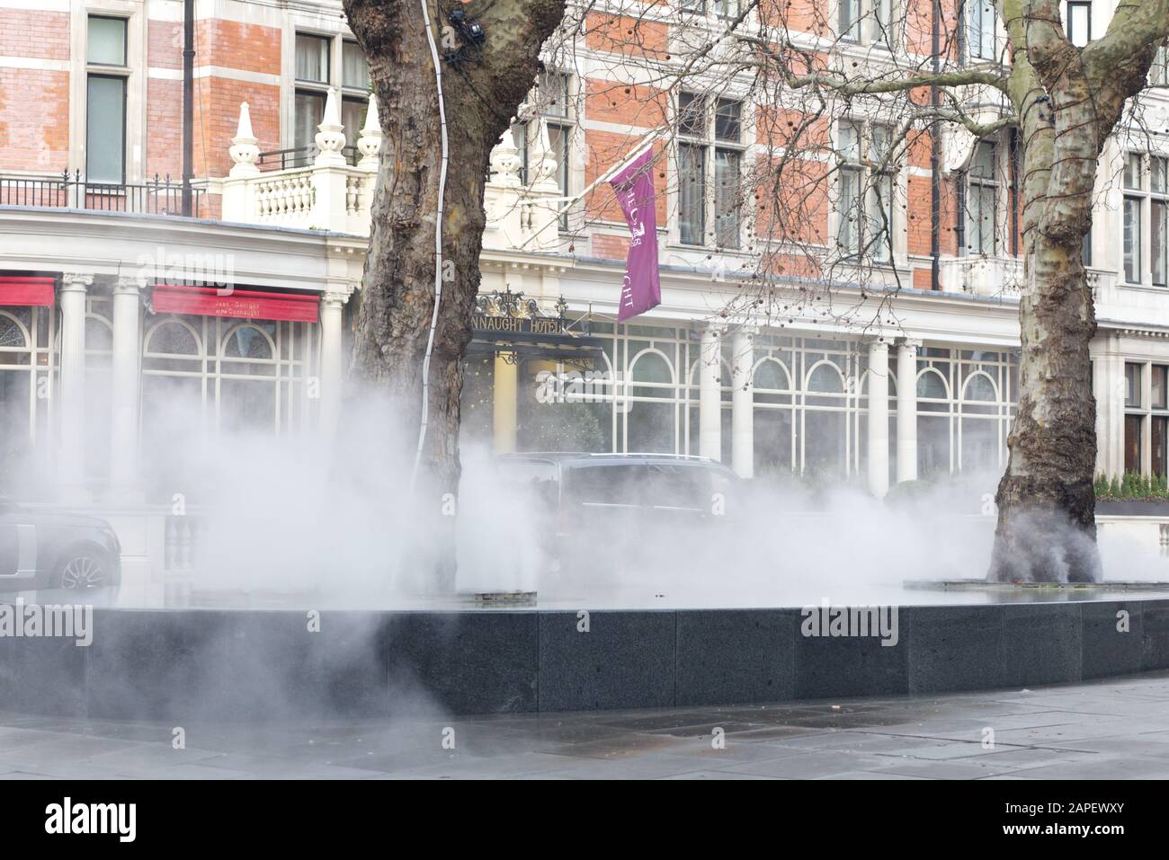 steam rising from the water feature outside the connaught hotel, London ...