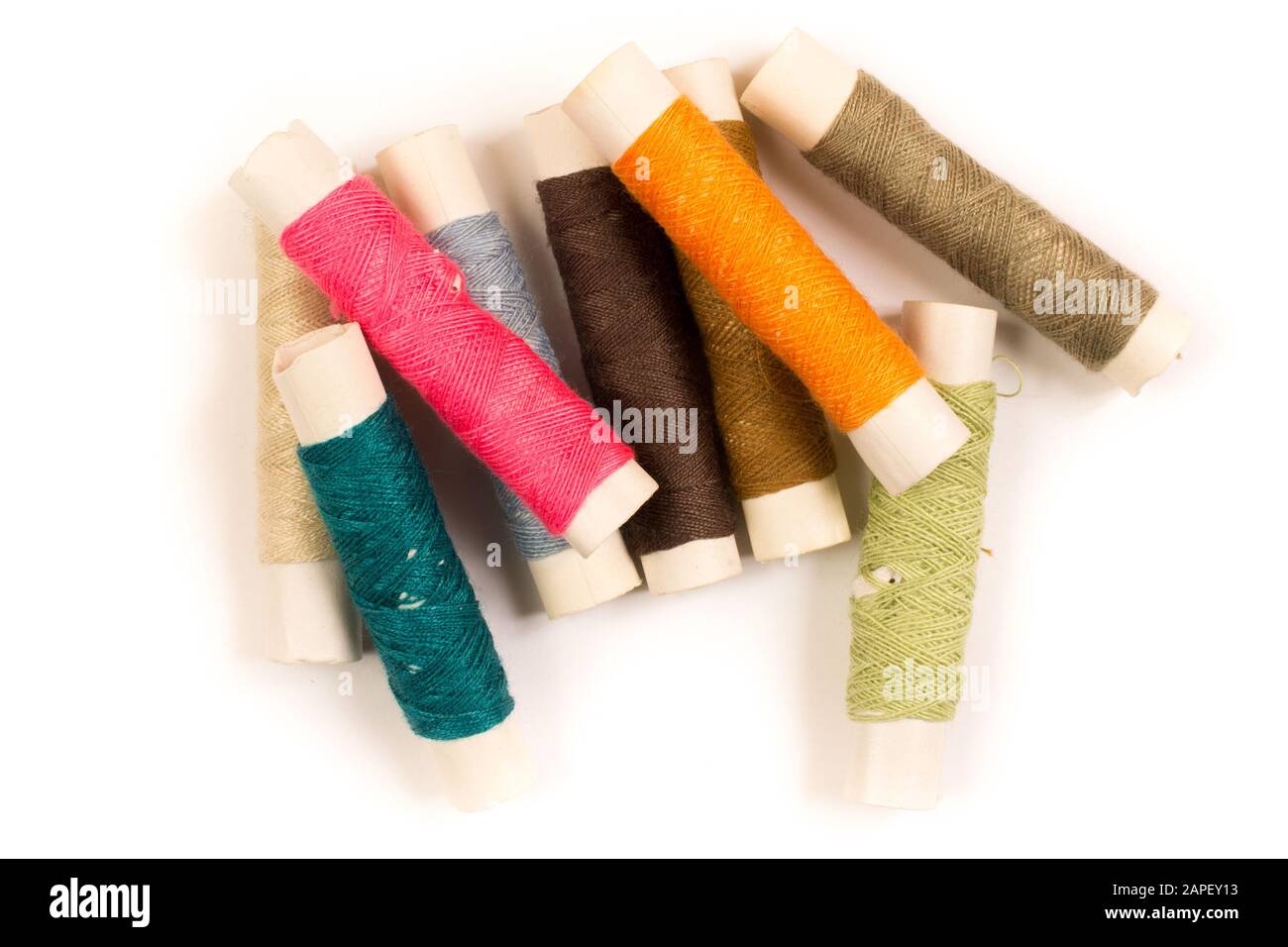 Colorful cotton yarns on rolls for sewing. Thread spools used in fabric ...