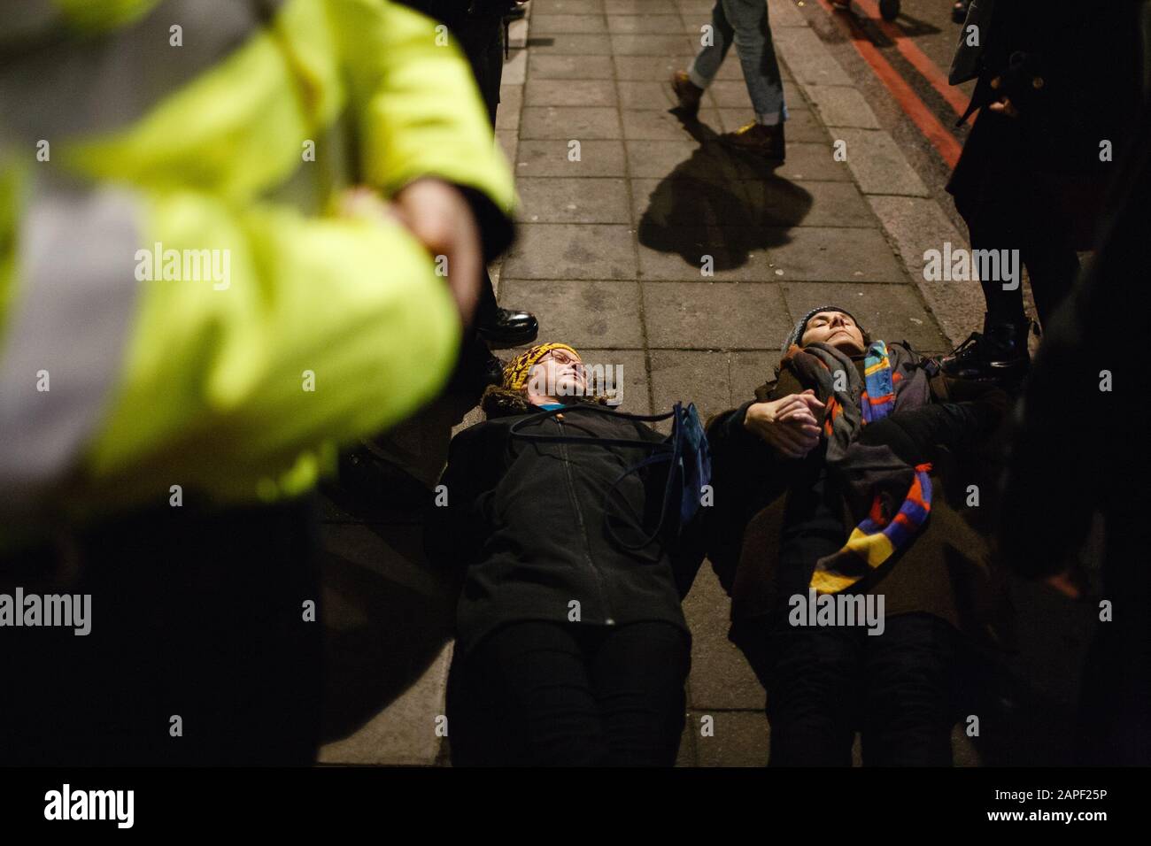 Anti-arms trade activists lie on the ground during a protest outside ...