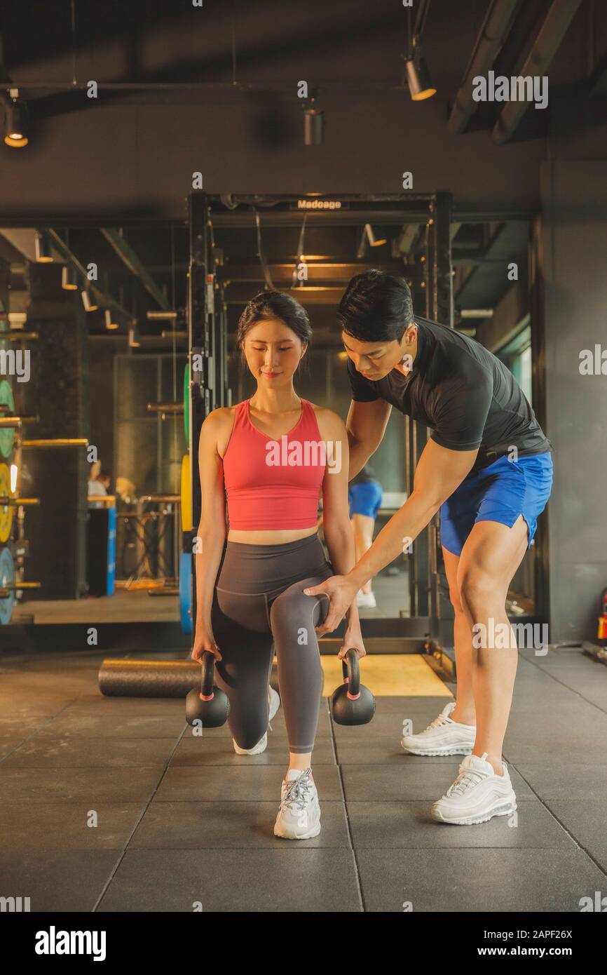 Male and female exercising in gym. Sport, fitness, weightlifting and ...