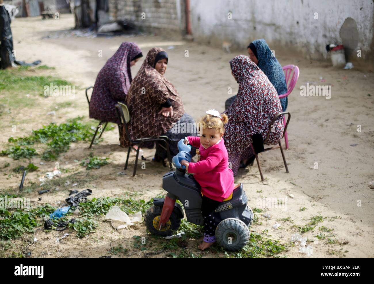 A Palestinian girl plays barefoot next to her family in the Al-Zuhur ...