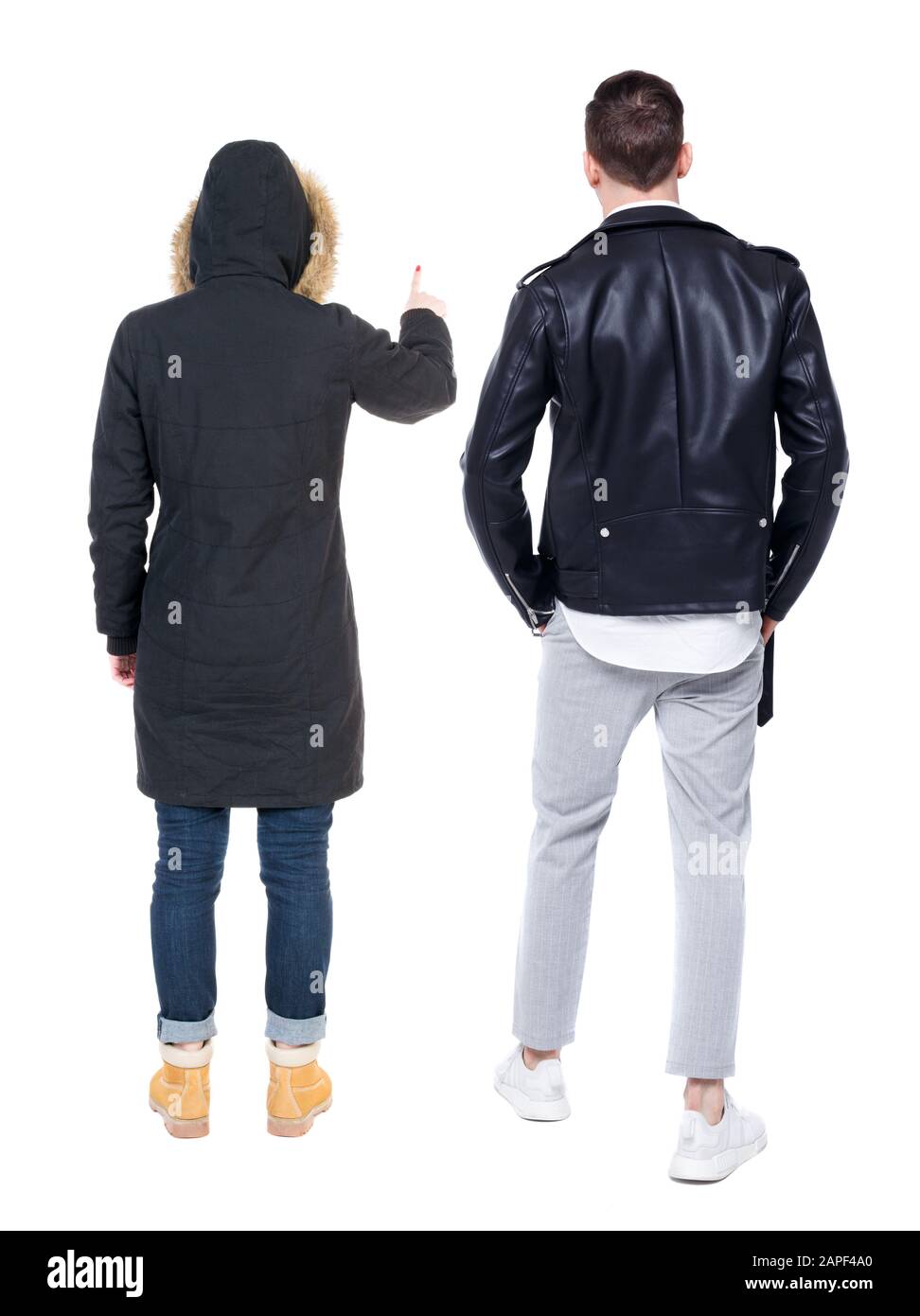 Back view of couple couple in winter jackets pointing. beautiful ...