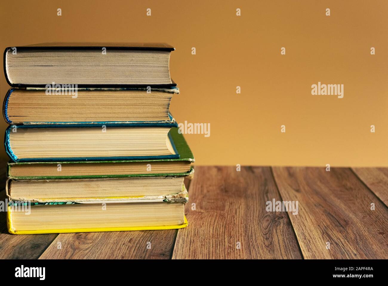 A stack of old books with yellow pages. Book binding. Knowledge and ...