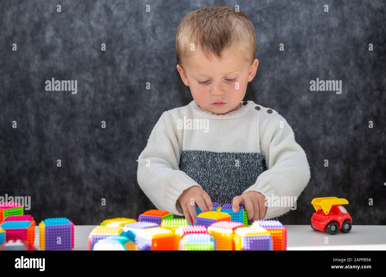 a two years old baby playing with cubes Stock Photo - Alamy