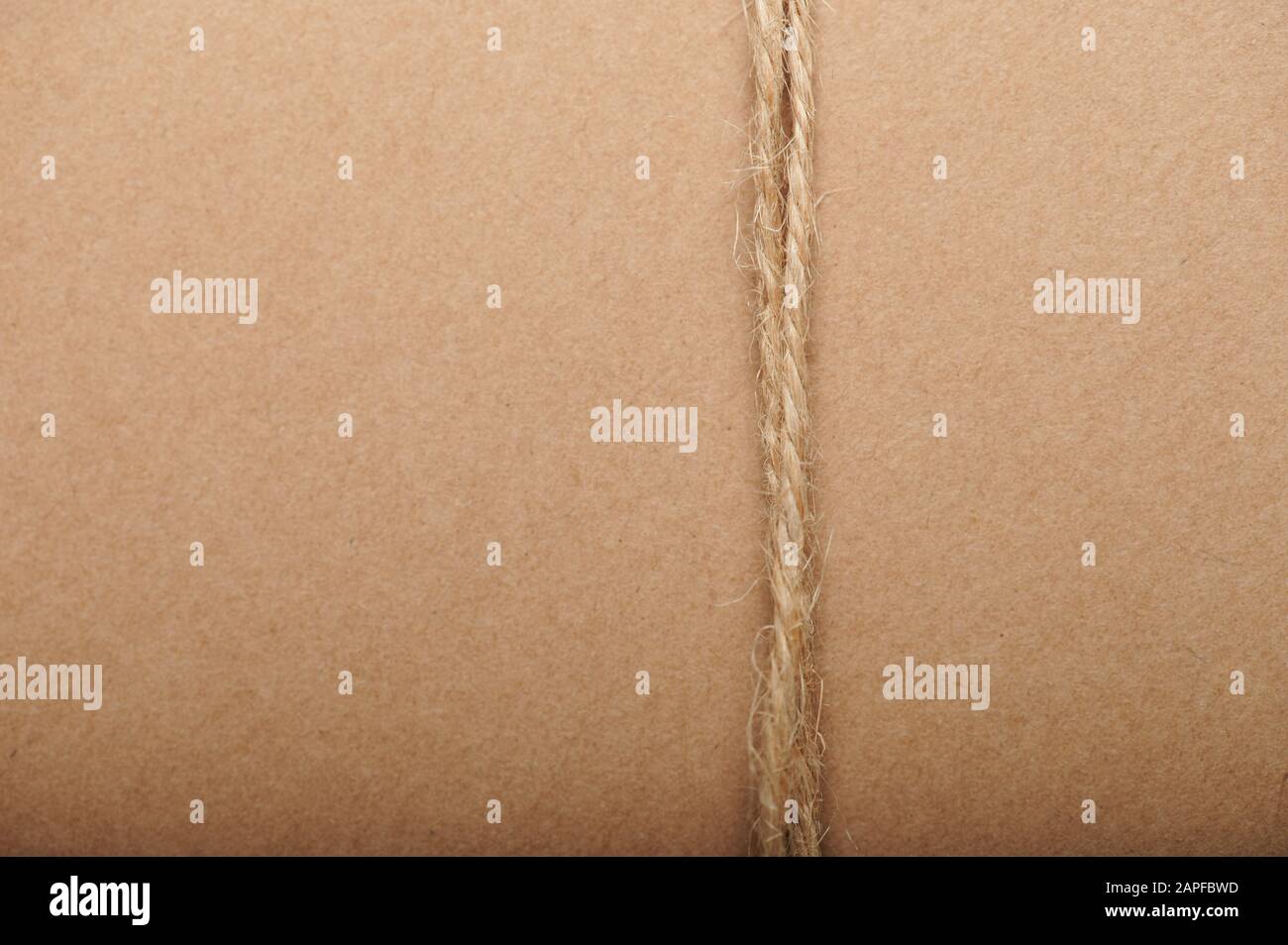 Twine brown string on paper carton background Stock Photo - Alamy
