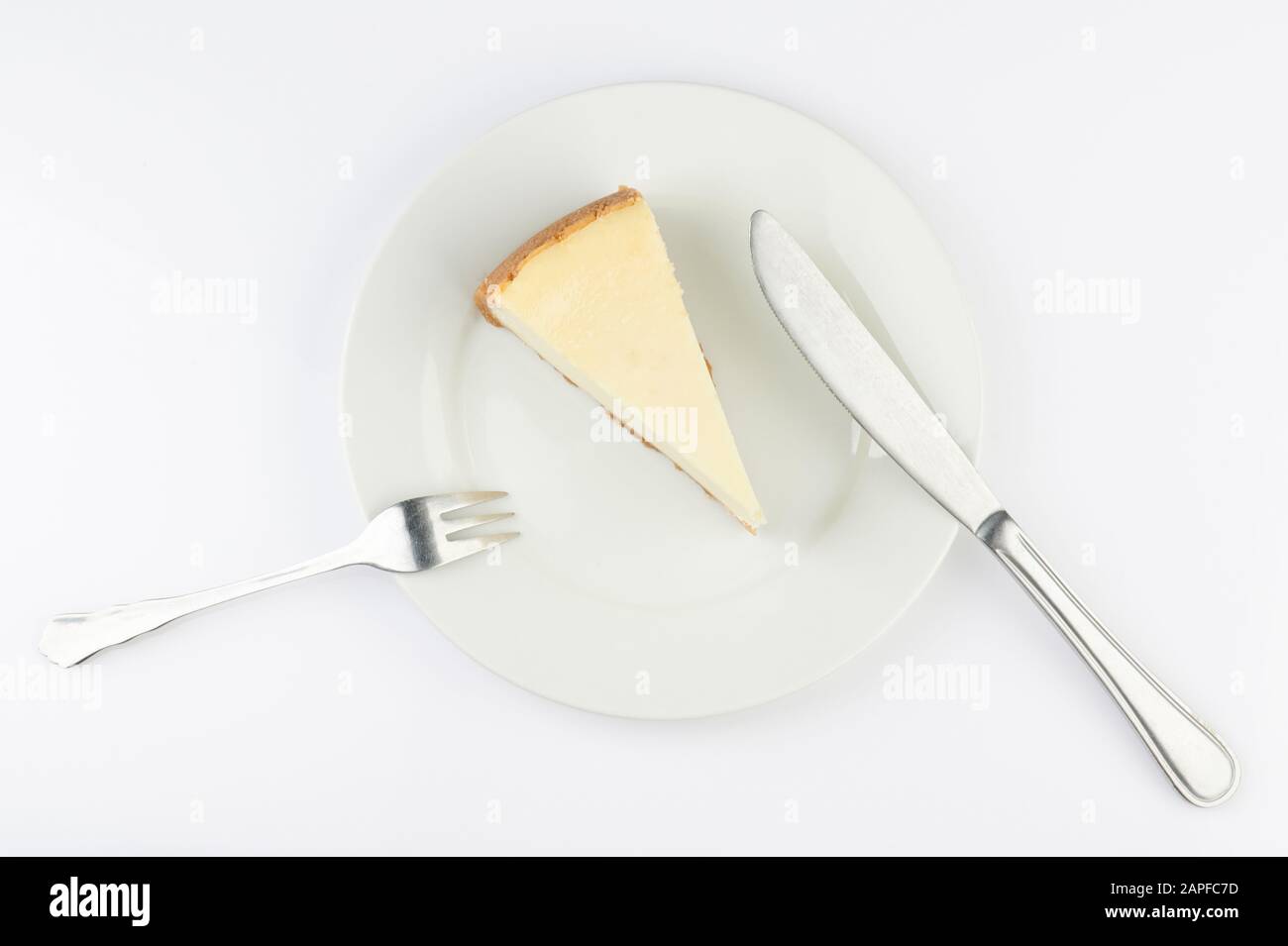 Cheesecake on plate above top view with fork and knife isolated Stock ...