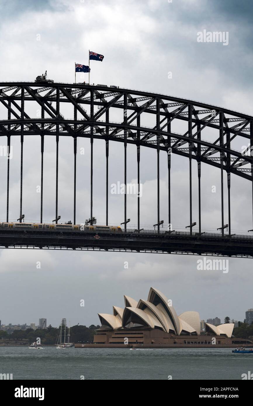 Train crossing Sydney Harbour Bridge with Sydney Opera House in ...