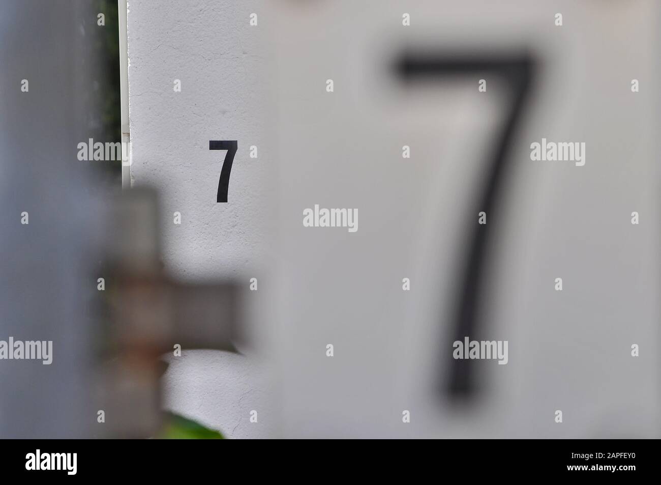 A house number plaque, showing the number seven (7 Stock Photo - Alamy