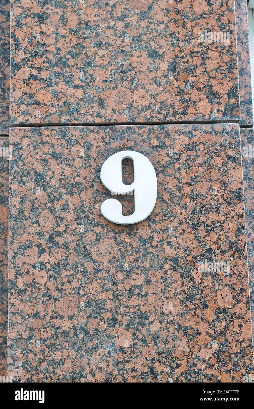 A house number plaque, showing the number nine (9 Stock Photo - Alamy