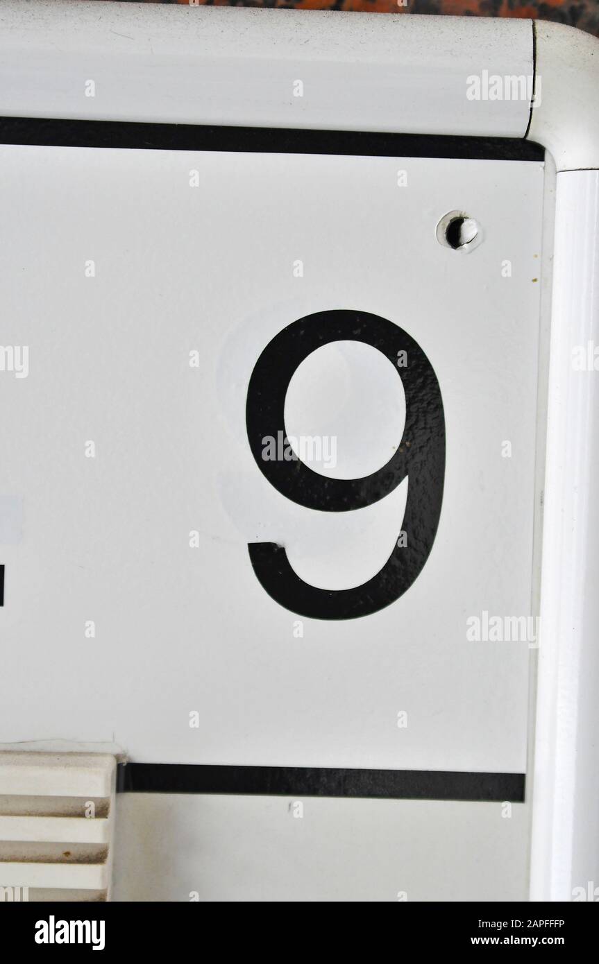 A house number plaque, showing the number nine (9 Stock Photo - Alamy