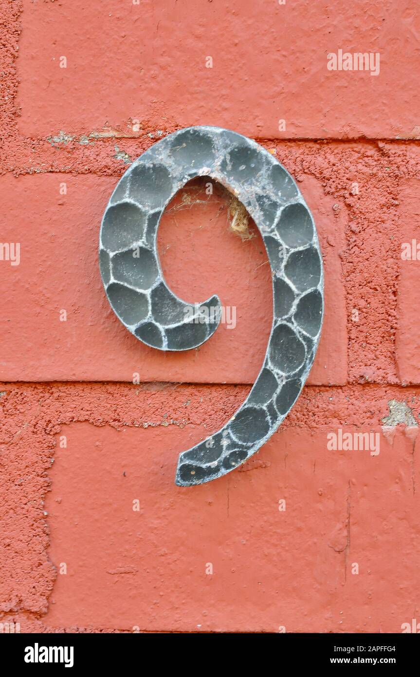 A house number plaque, showing the number nine (9 Stock Photo - Alamy