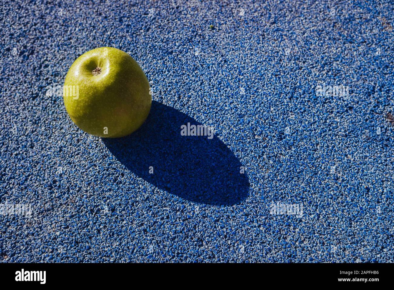 Apple isolated on the rough ground of strange color Stock Photo - Alamy