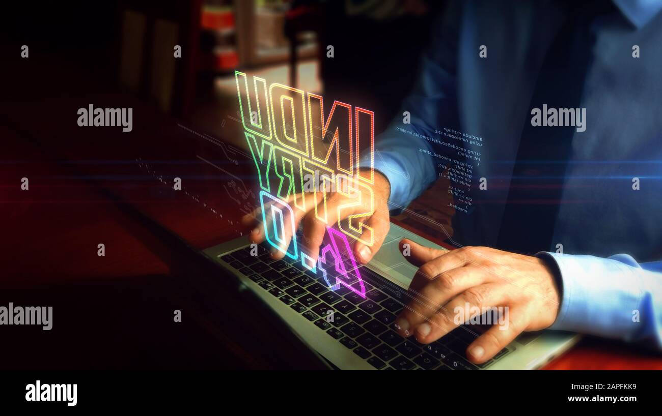 Man typing on laptop with industry 4.0 hologram screen over keyboard ...