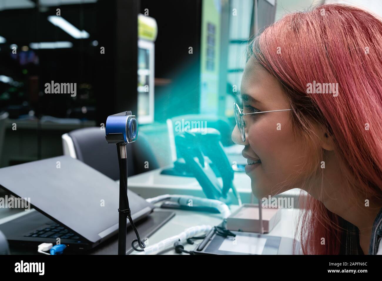 Diverse woman using biometric scanner to confirm identity and pay for ...