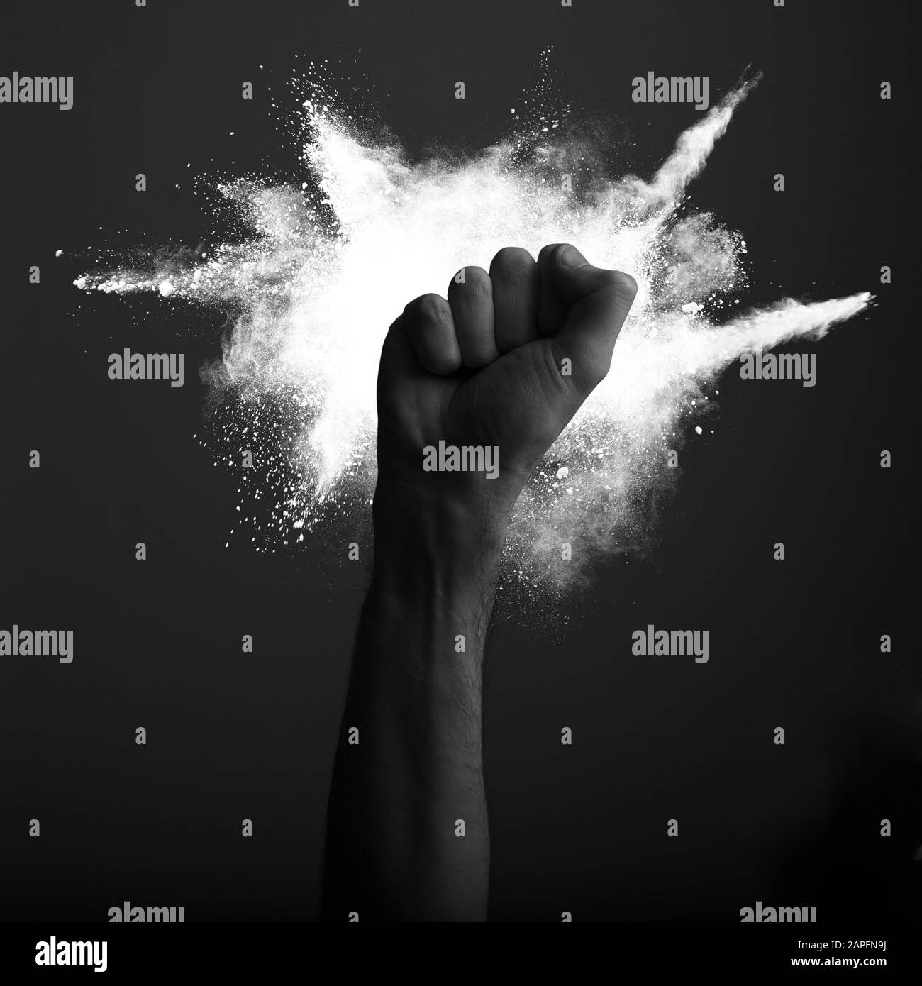 Raised clenched fist with white powder explosion, power, protest ...