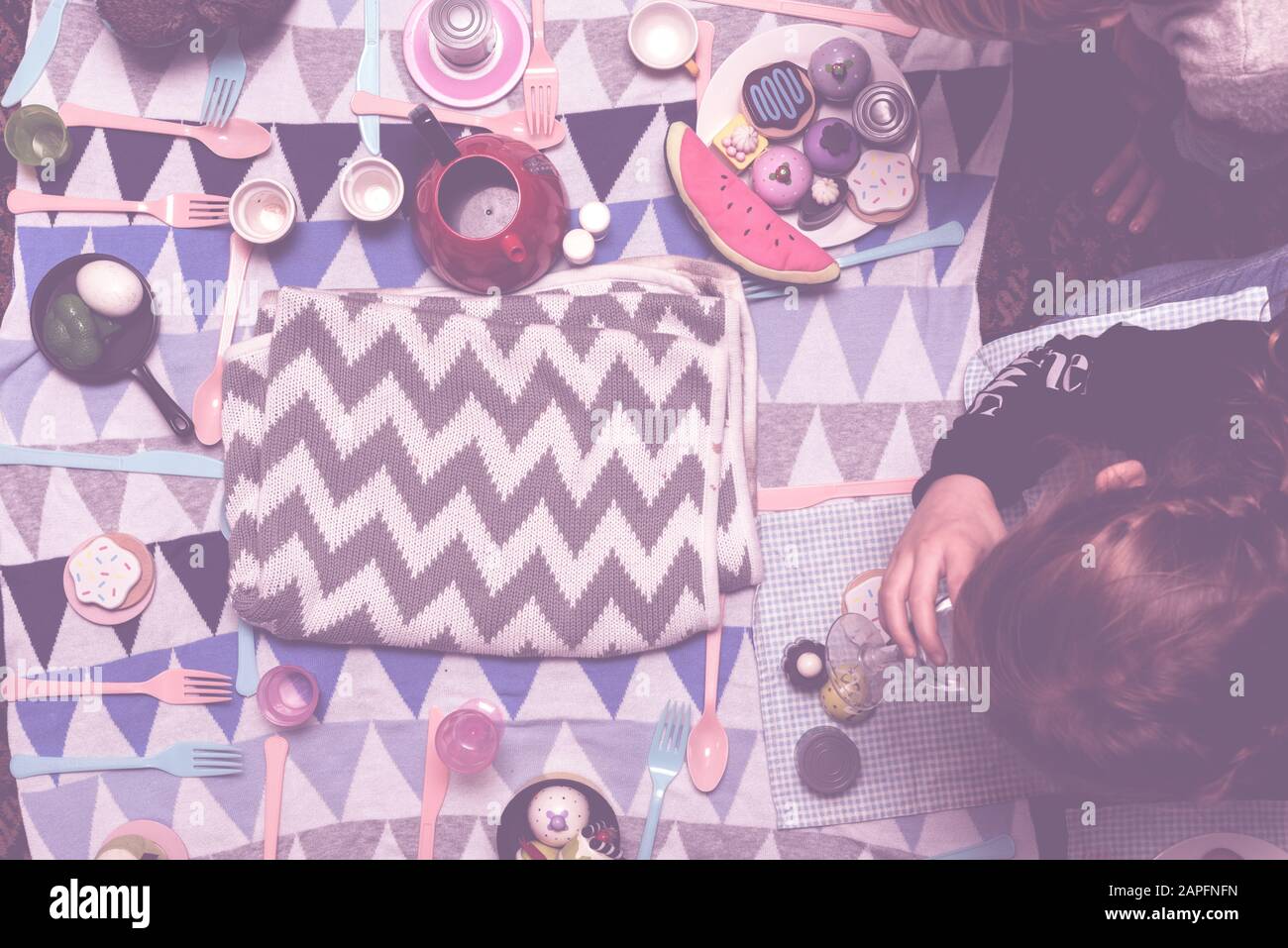 kids play make believe tea party with children's toys and tea set in ...