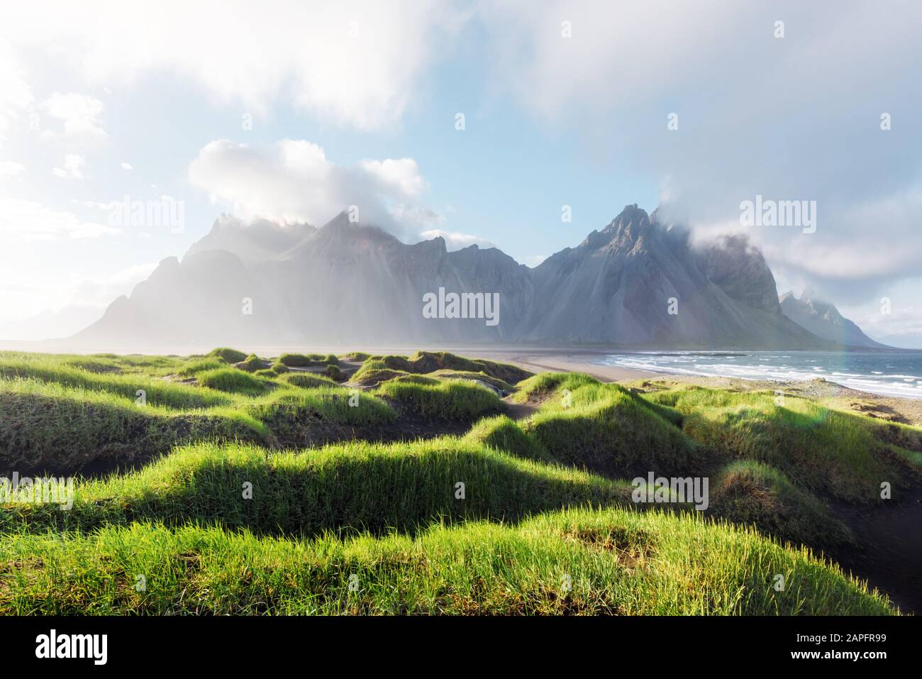 Gorgeous landscape with black sand desert dunes and grassy bumps near ...