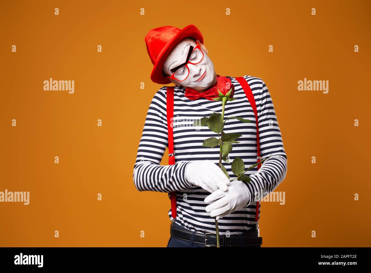 Smilling mime man with white face in red hat and striped t-shirt ...