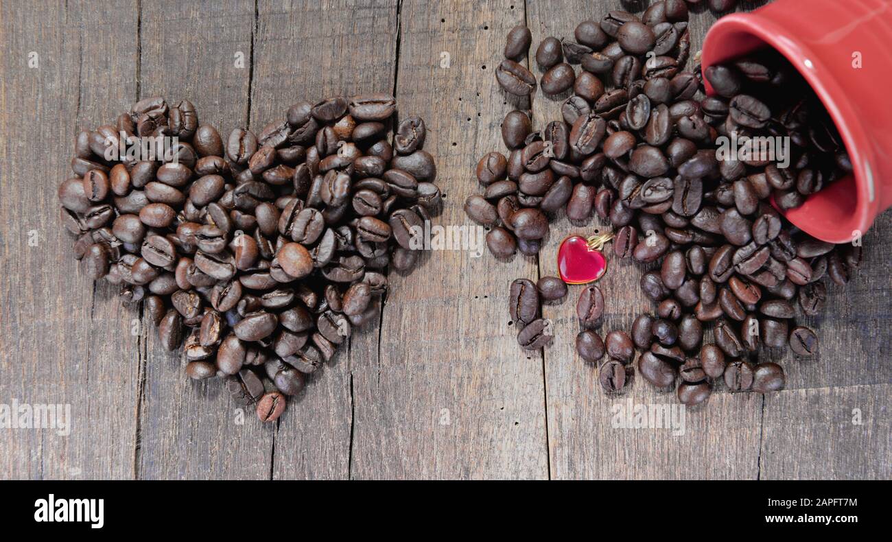 heap of coffee beans forming a heart and cup spilled with a jewel heart ...