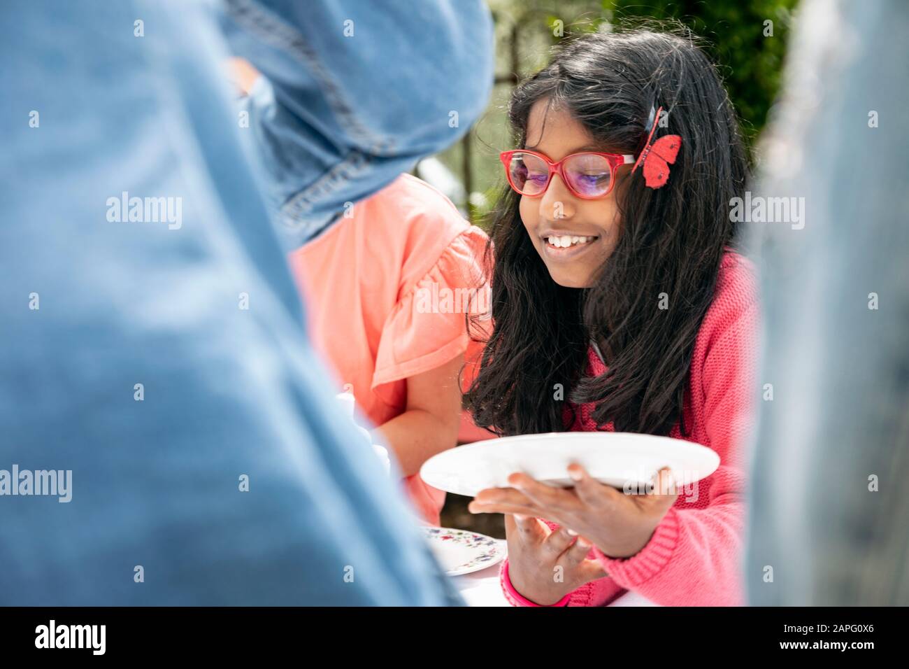 Young girl with plate at outdoor family lunch, Florence, Italy Stock ...