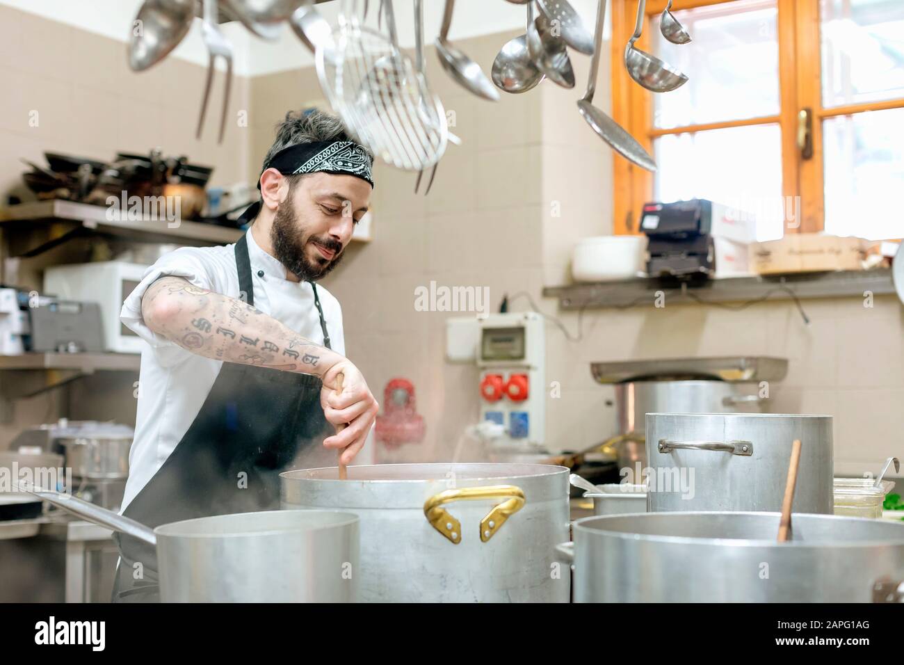 Chef cooking in kitchen Stock Photo - Alamy
