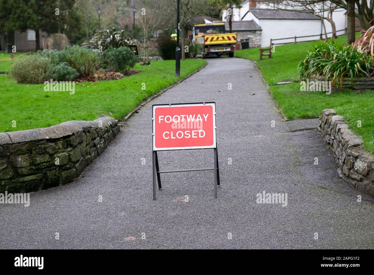 A sign indicating a footway footpath closed in a park in Newquay in ...