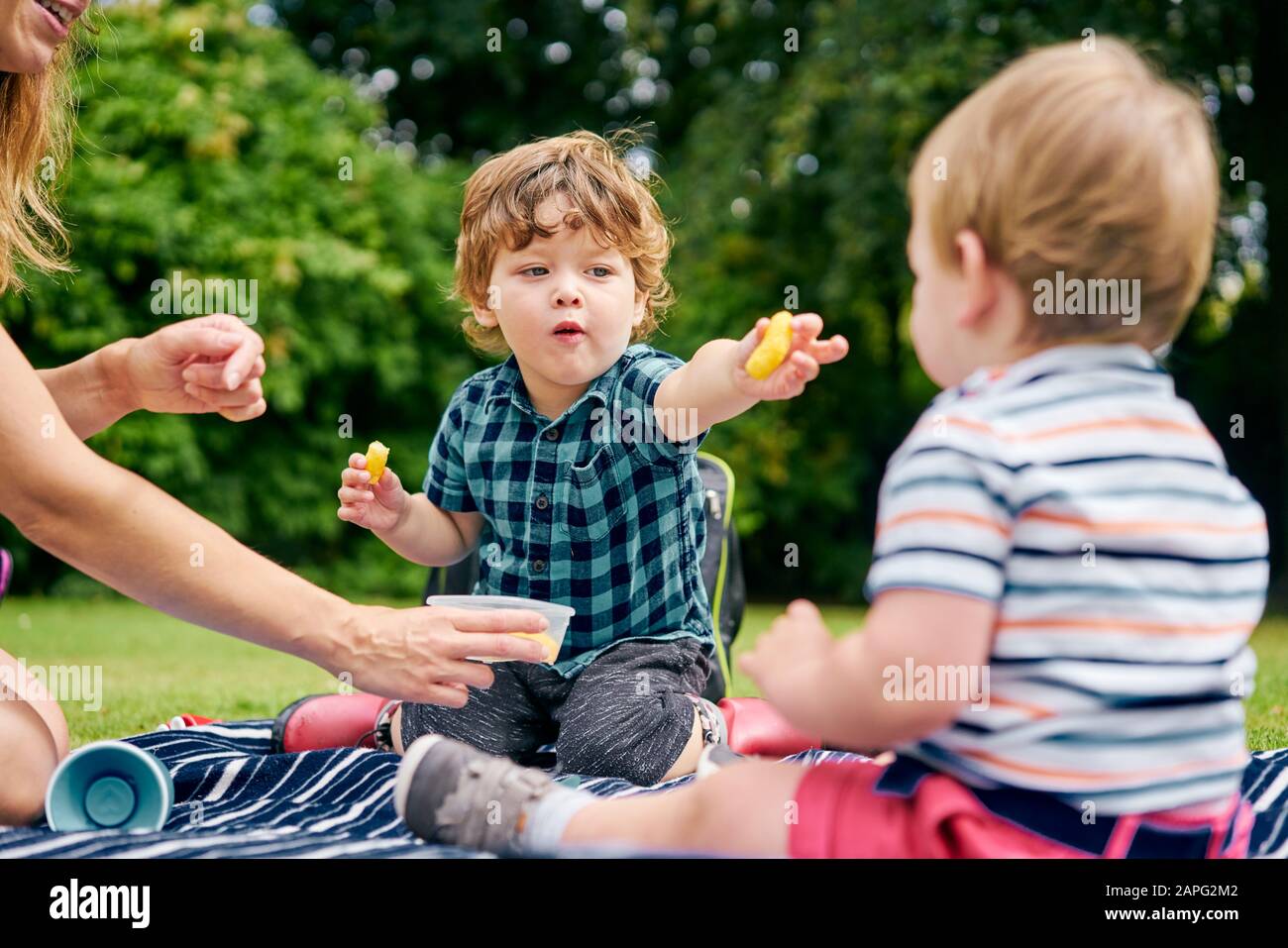 Child sharing snack hi-res stock photography and images - Alamy