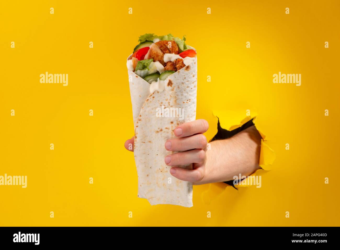 Hand giving a fresh doner roll. Delicious Turkish dish Stock Photo - Alamy