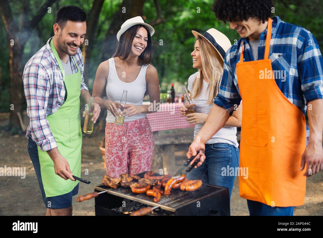 Group of happy young friends having barbecue party, outdoors Stock ...