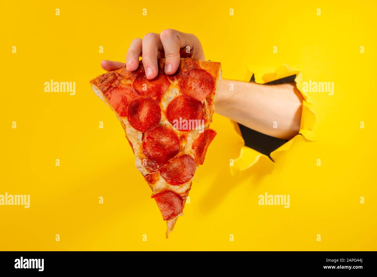 Hand showing a slice of pizza Stock Photo - Alamy