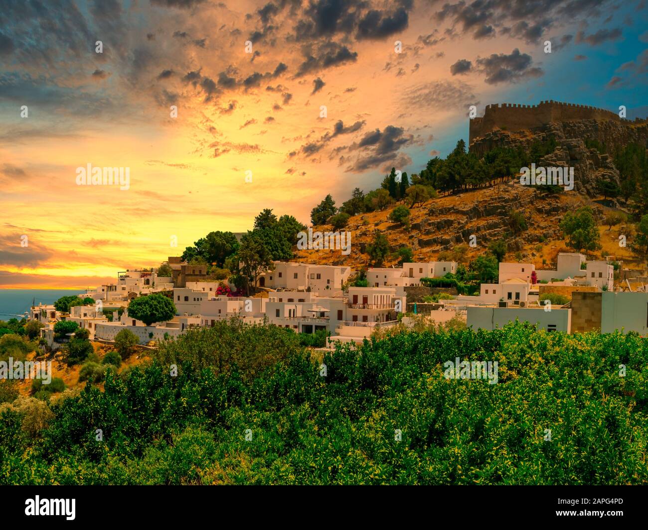 The historic city of Lindos and the Acropolis of Lindos at a beautiful ...