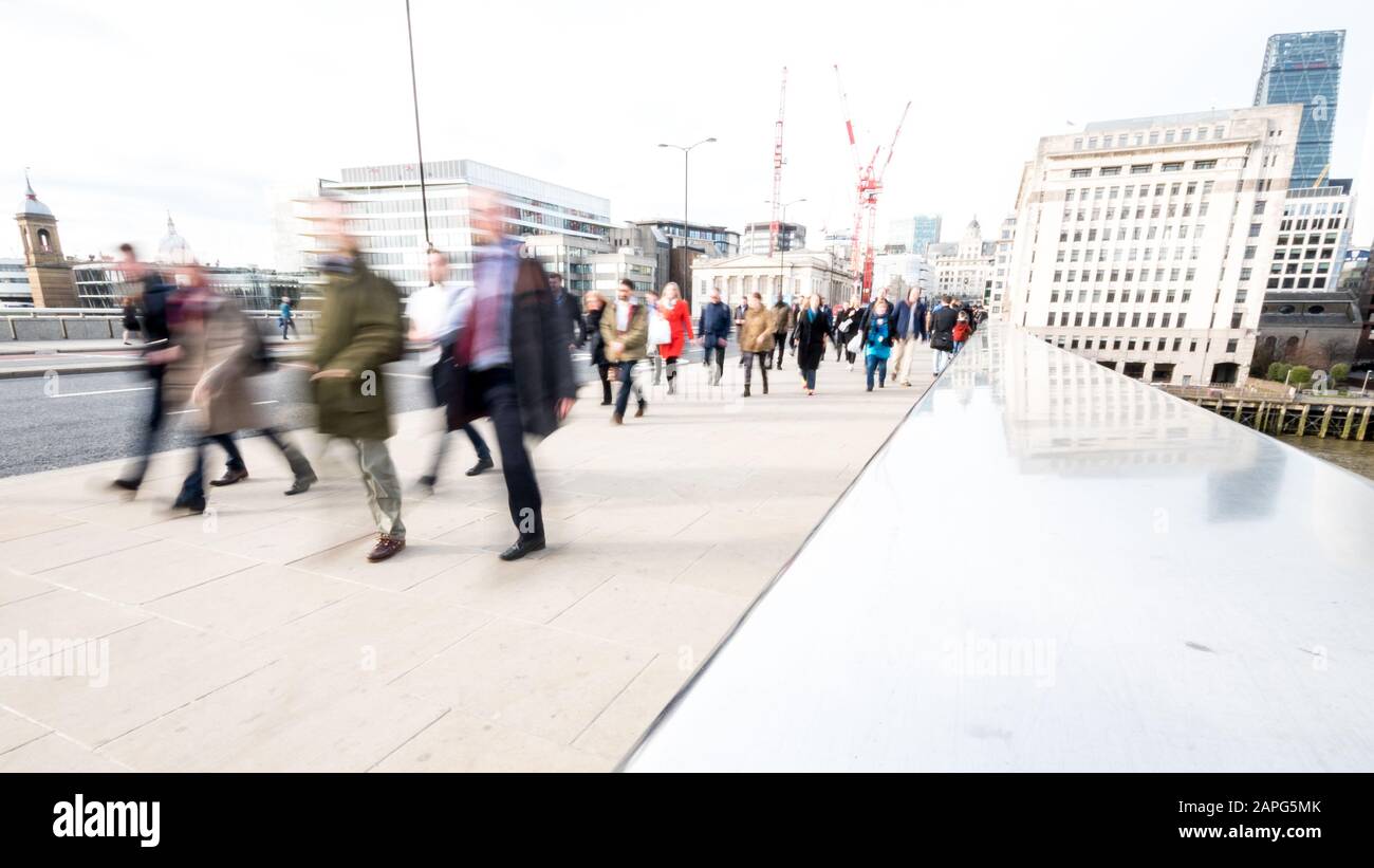 London rush hour. Commuters and office workers crossing London Bridge ...