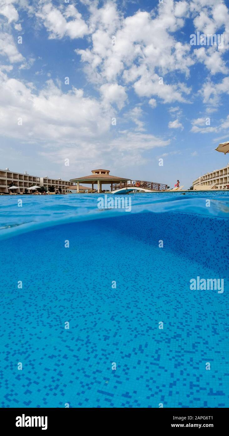 Underwater split shot photos of the hotel resort pool Stock Photo - Alamy