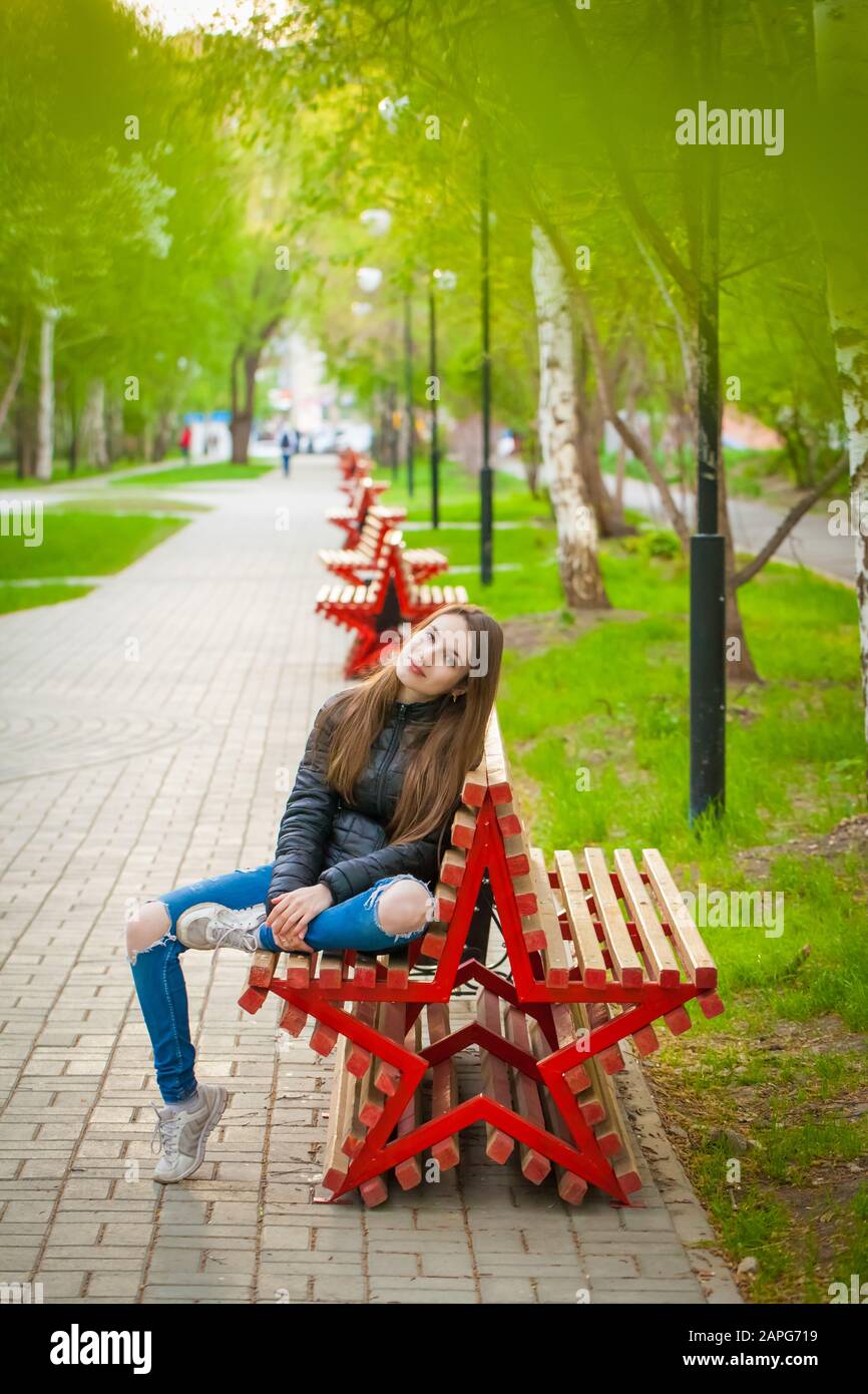 Beautiful girl on a park bench. relaxation. Star Stock Photo - Alamy