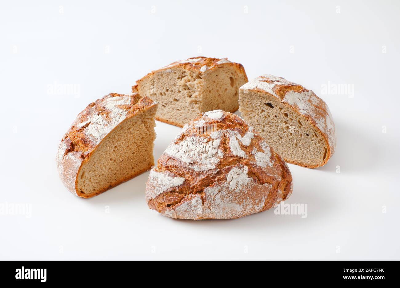 Round loaf of rustic bread cut into quarters Stock Photo - Alamy