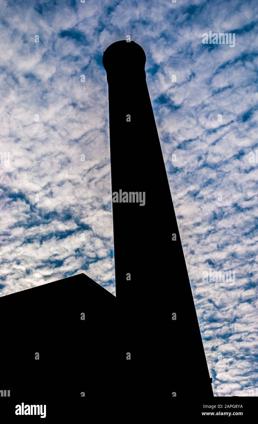 Silhouette of tall chimney on old factory building, Saltaire, Yorkshire ...