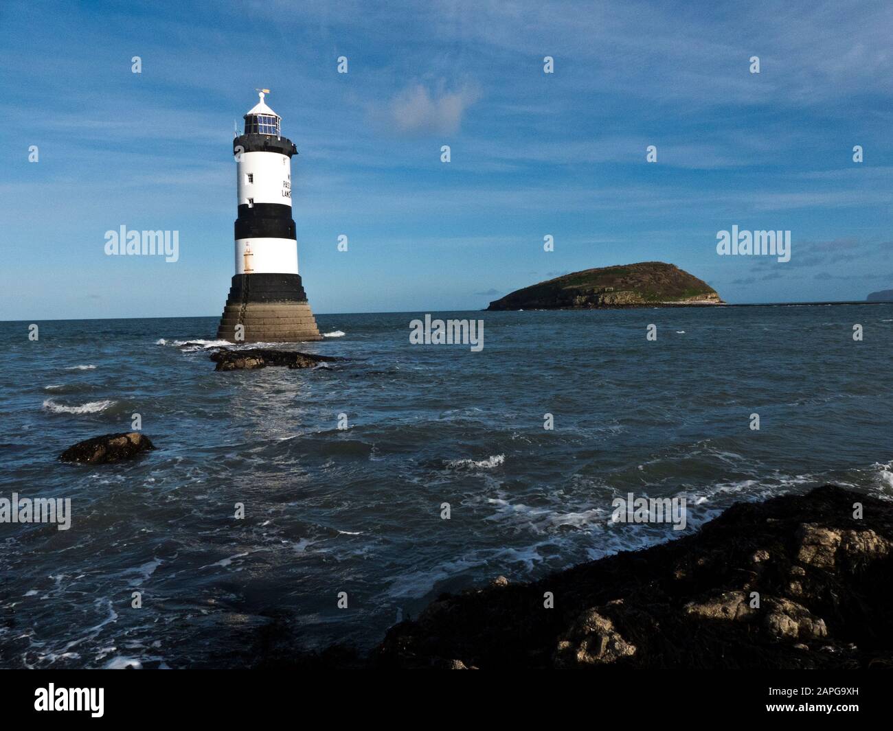 The famous Penmon Lighthouse protects sailors from the rocky shoals of ...