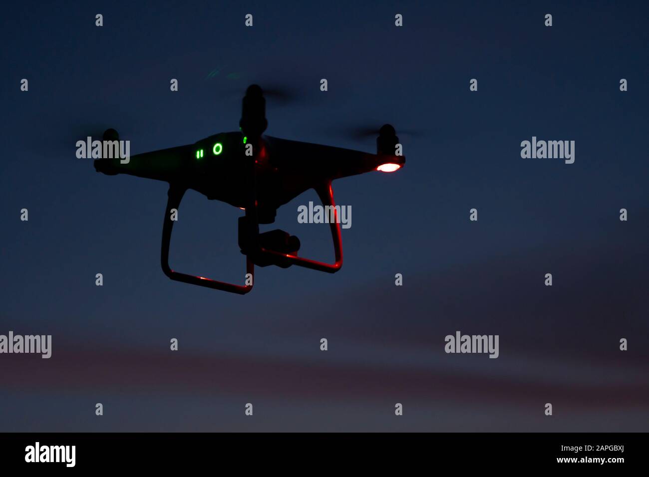 Drone in flight at sunset Stock Photo - Alamy