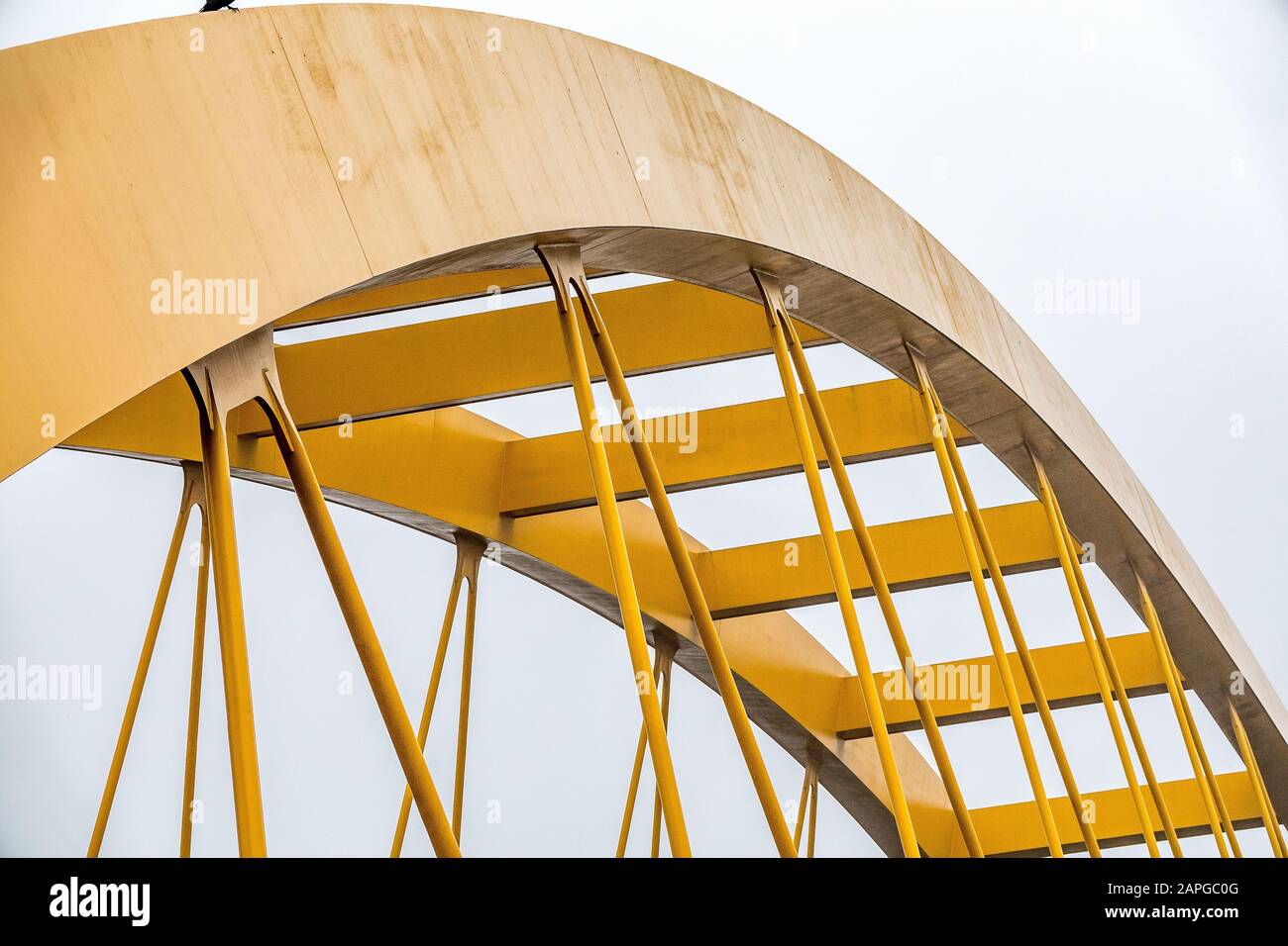 Closeup shot of the upper part of a yellow arch under a cloudy sky ...