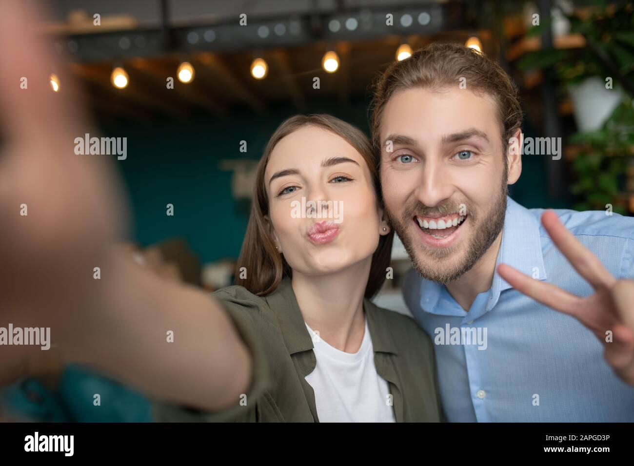 Couple making faces while taking a picture Stock Photo - Alamy