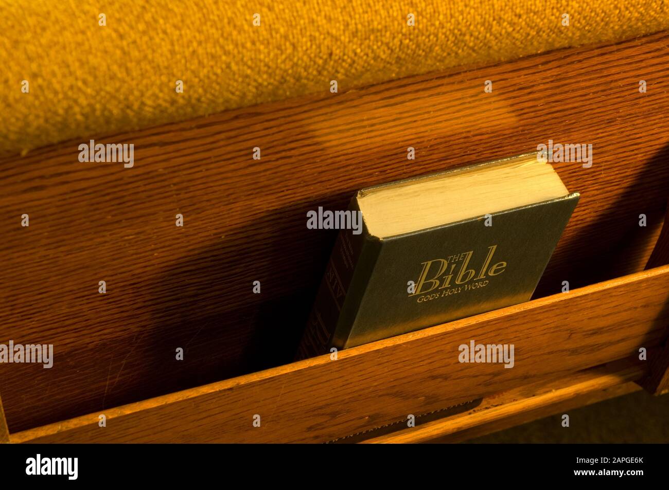 High angle view of the bible in a small bookshelf behind the chair in ...